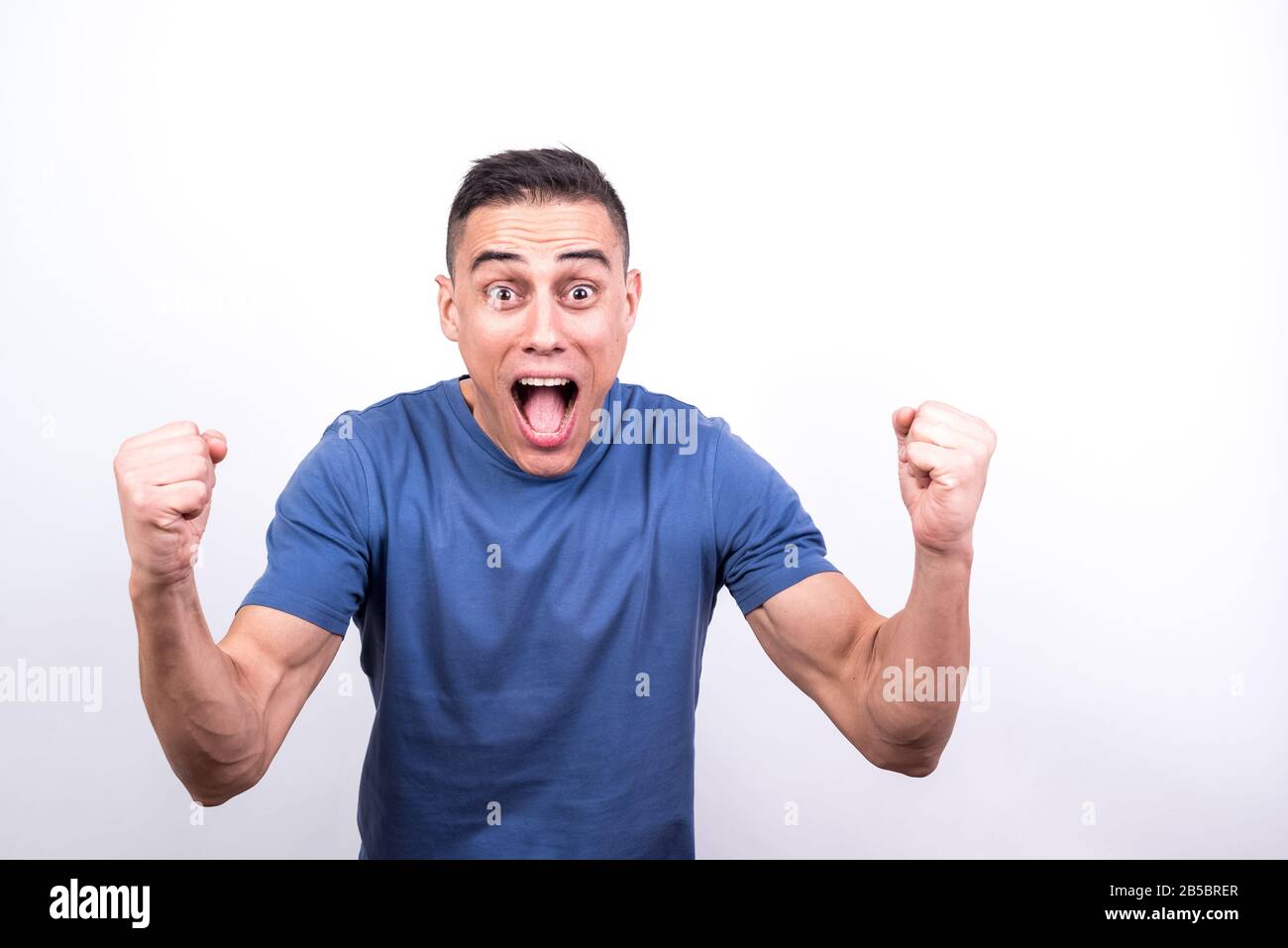 Euphoric man celebrating something. White background. Middle plane ...
