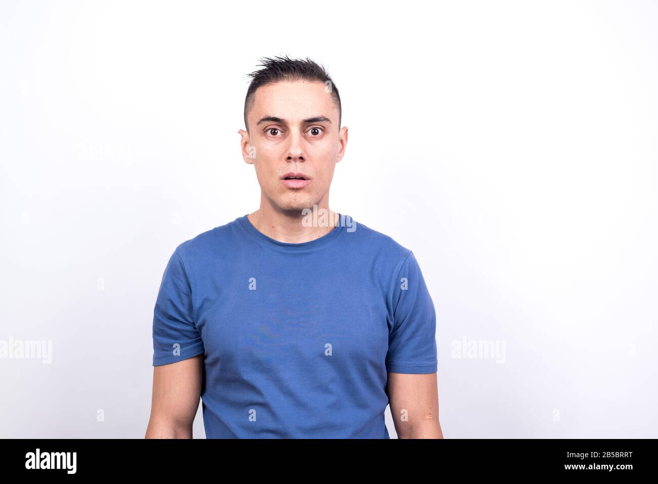 Man in shock. white background, medium shot Stock Photo - Alamy