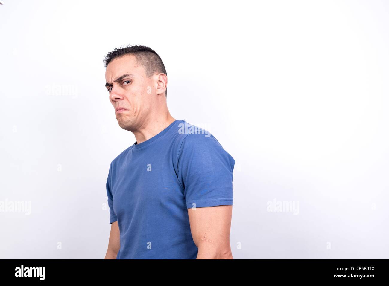 Distrustful man White background. Middle plane Stock Photo - Alamy