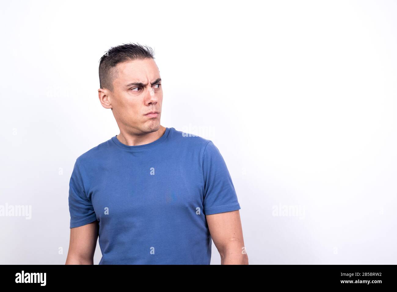 Distrustful man White background. Middle plane Stock Photo - Alamy