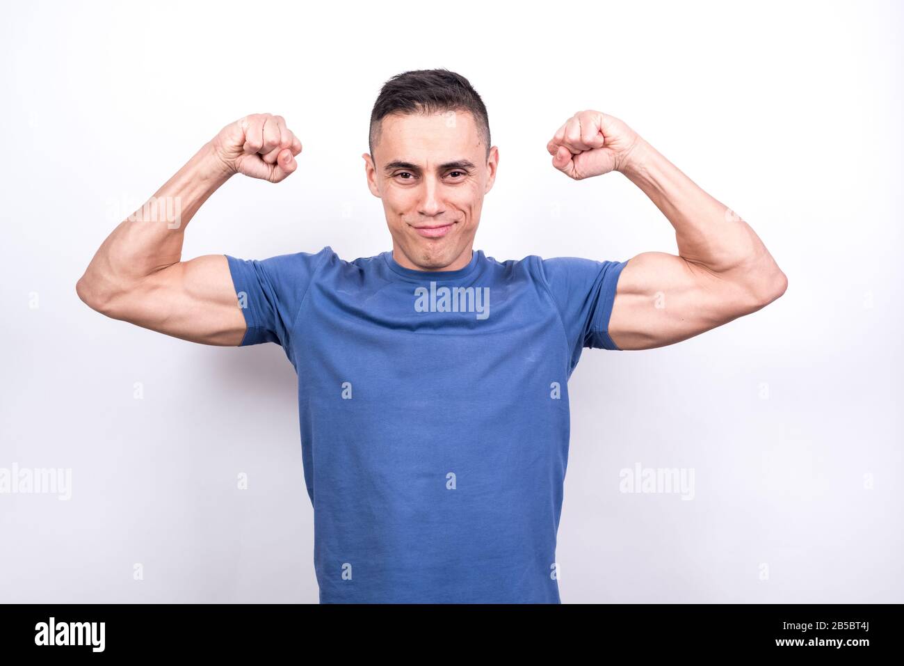 Man pulling out biceps. white background, medium shot Stock Photo - Alamy