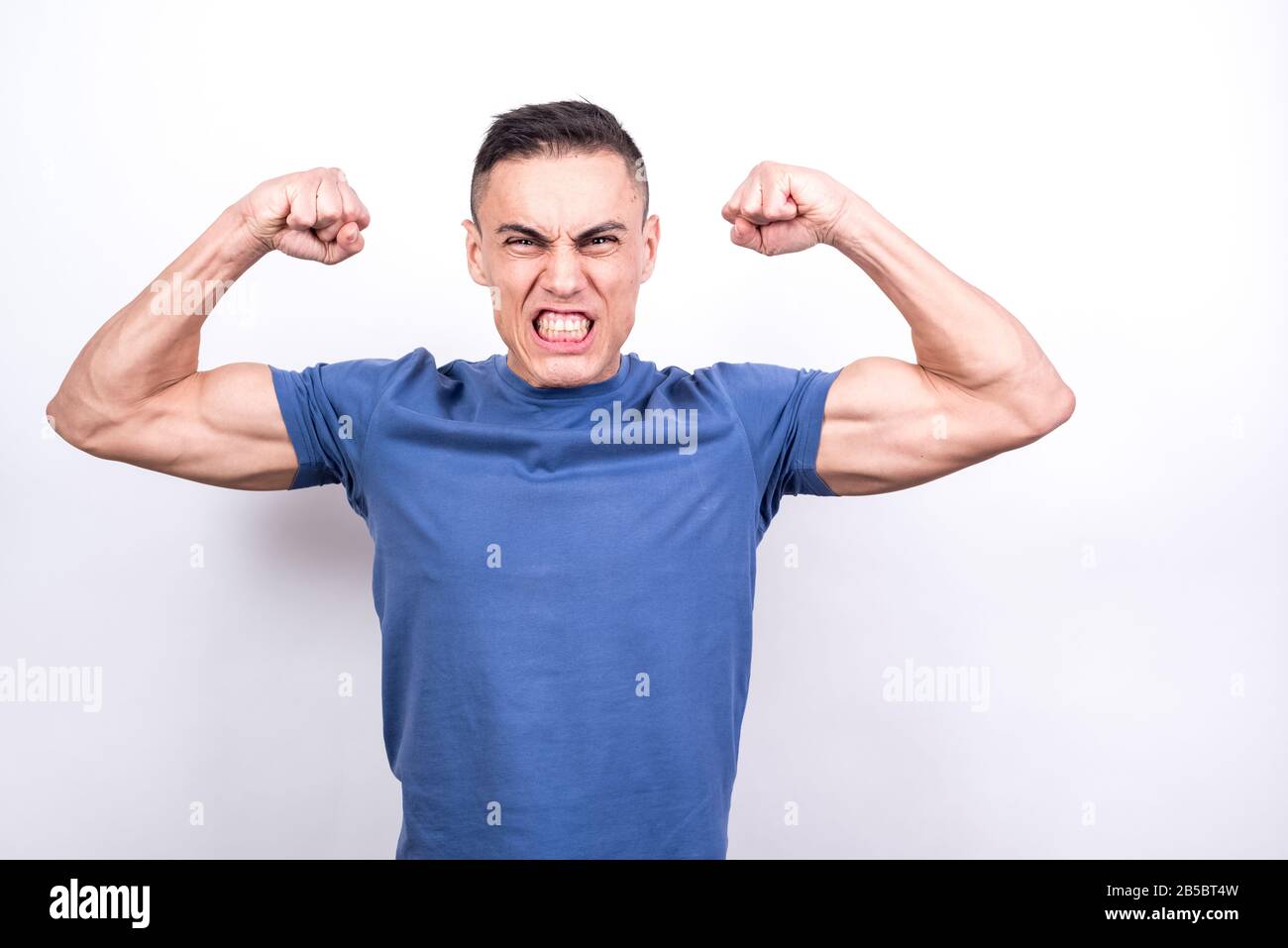 Man pulling out biceps. white background, medium shot Stock Photo - Alamy