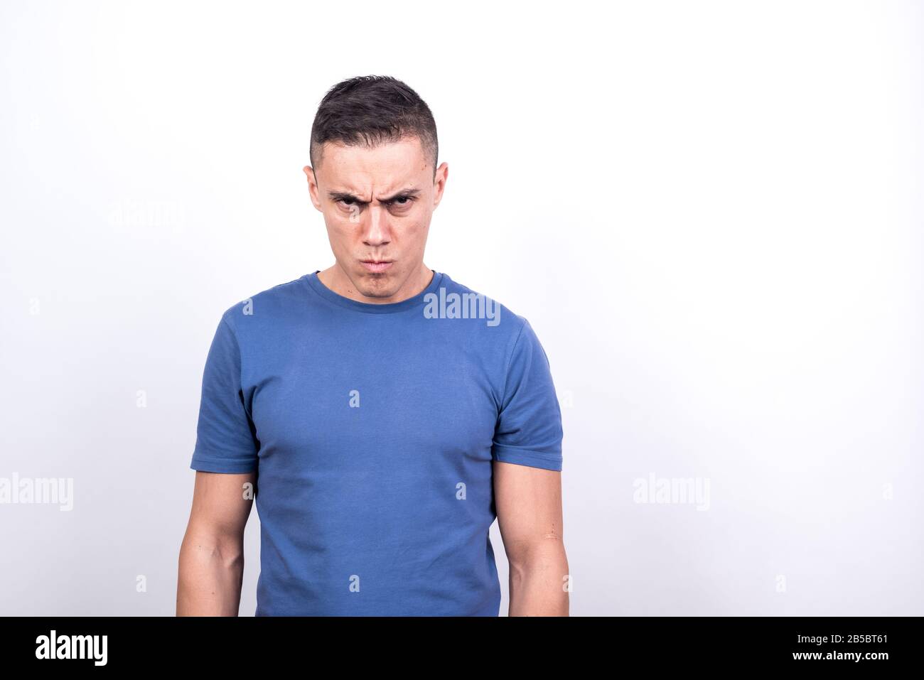 Angry man. white background, medium shot Stock Photo - Alamy