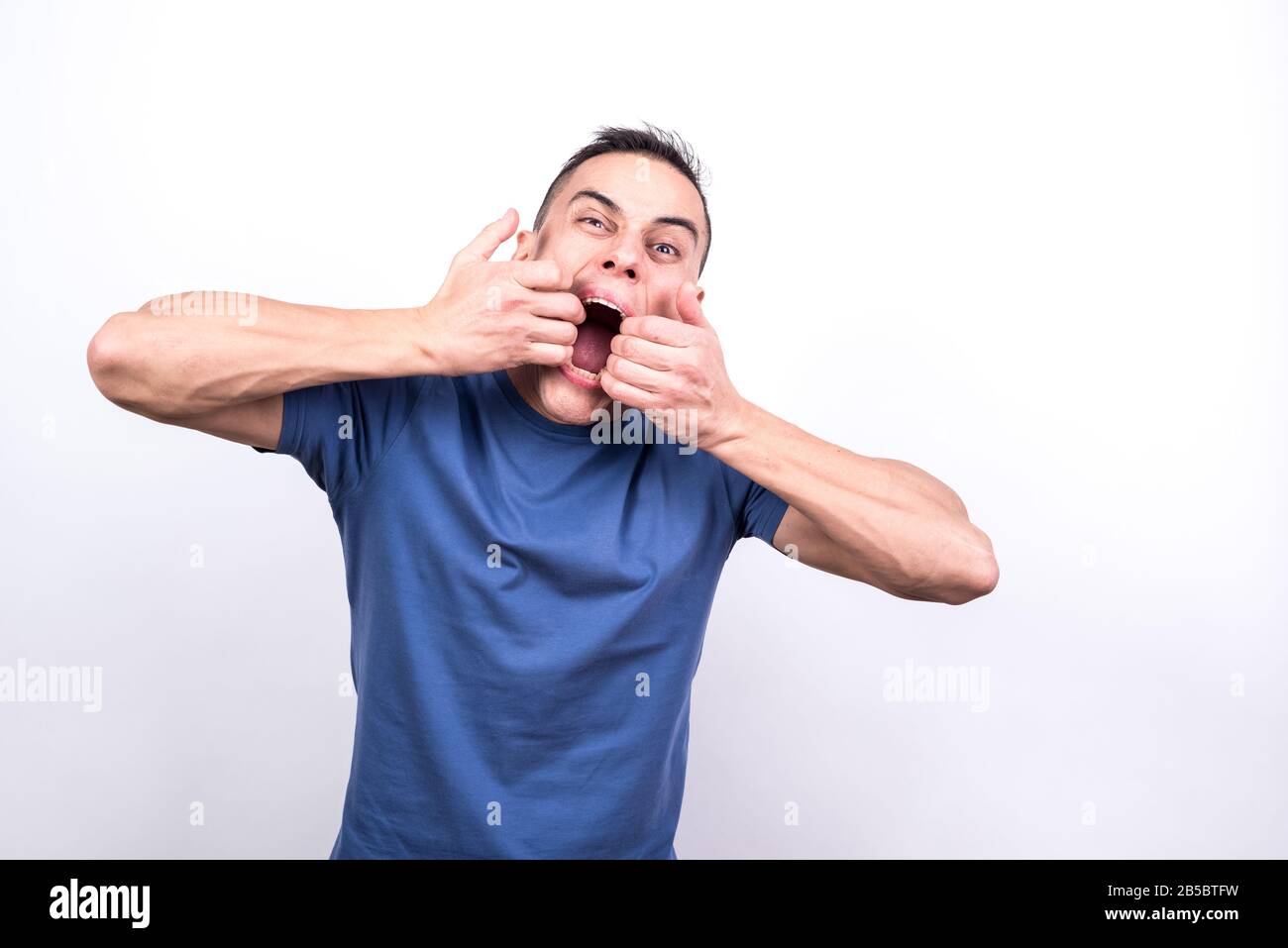 Man fooling around. White background, medium shot Stock Photo - Alamy