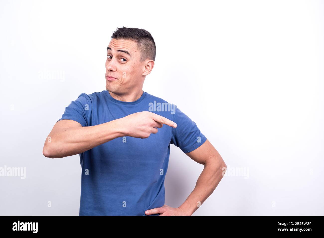 Smiling man pointing to copy space. White background, Medium shot Stock ...
