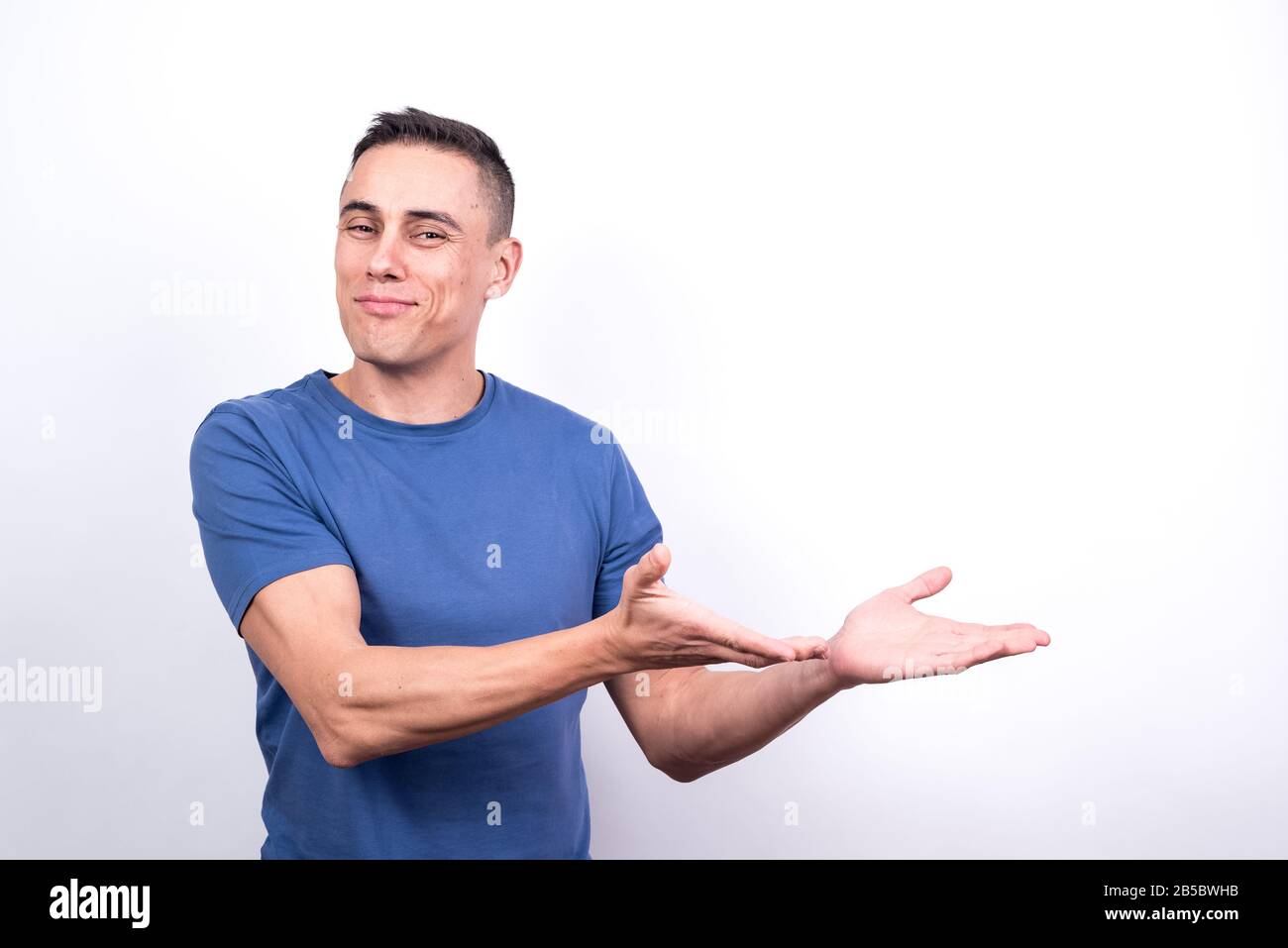 Smiling man pointing to copy space. White background, Medium shot Stock ...