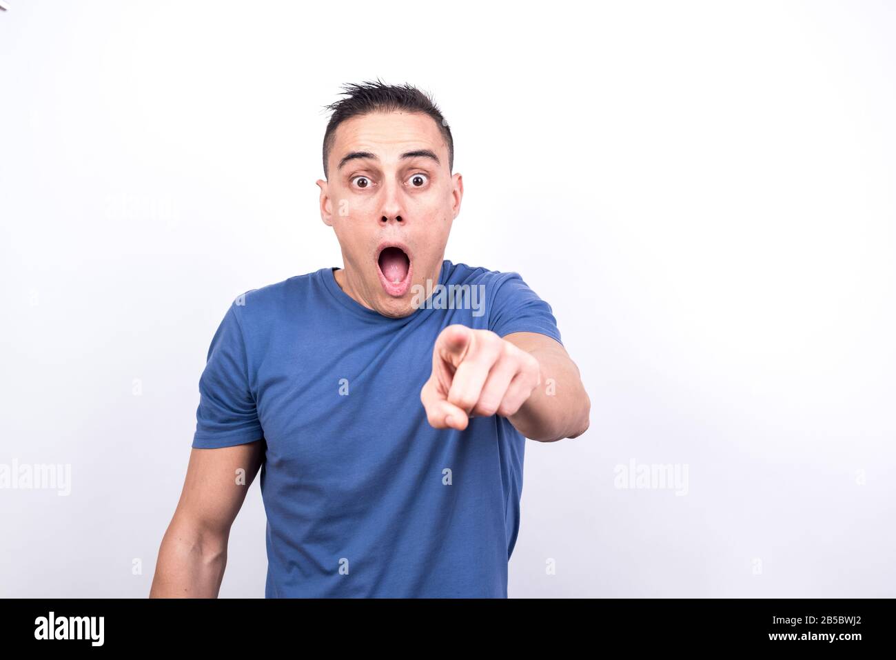 Man pointing in front with index finger. White background, Medium shot ...