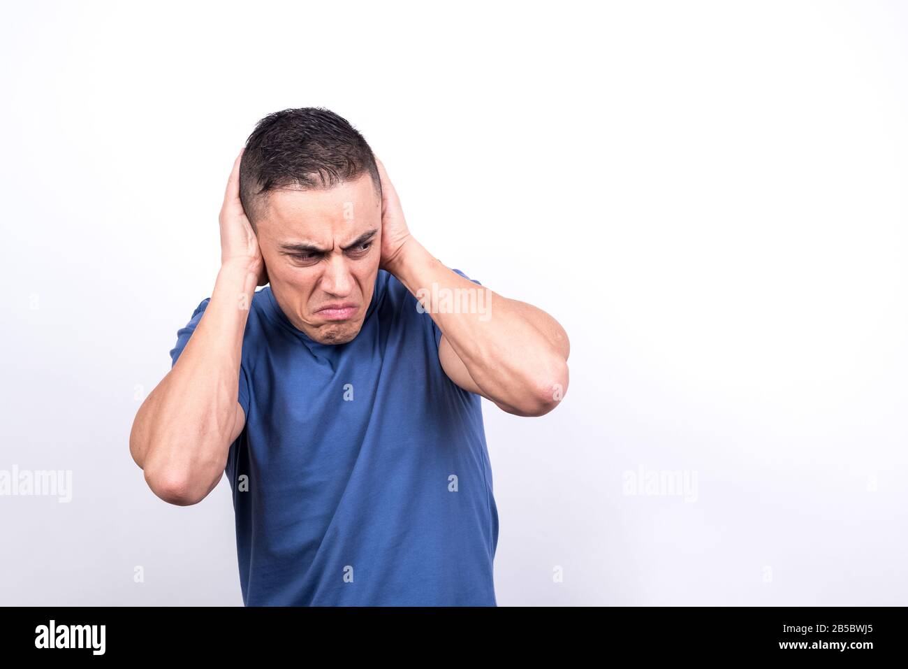 Man disgusted by noise. White background, Medium shot Stock Photo - Alamy