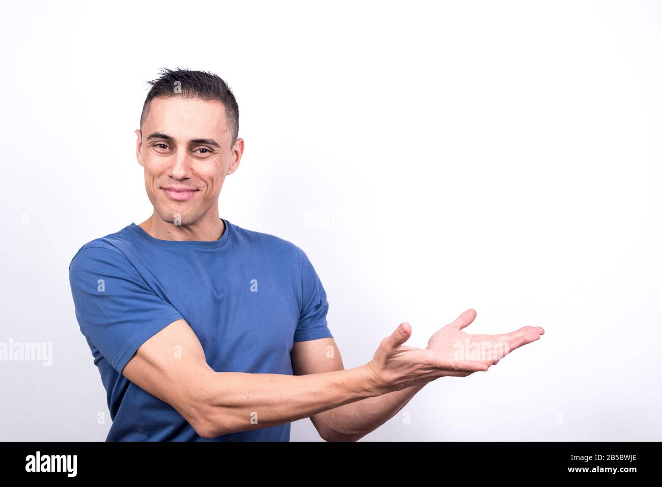 Smiling man pointing to copy space. White background, Medium shot Stock ...