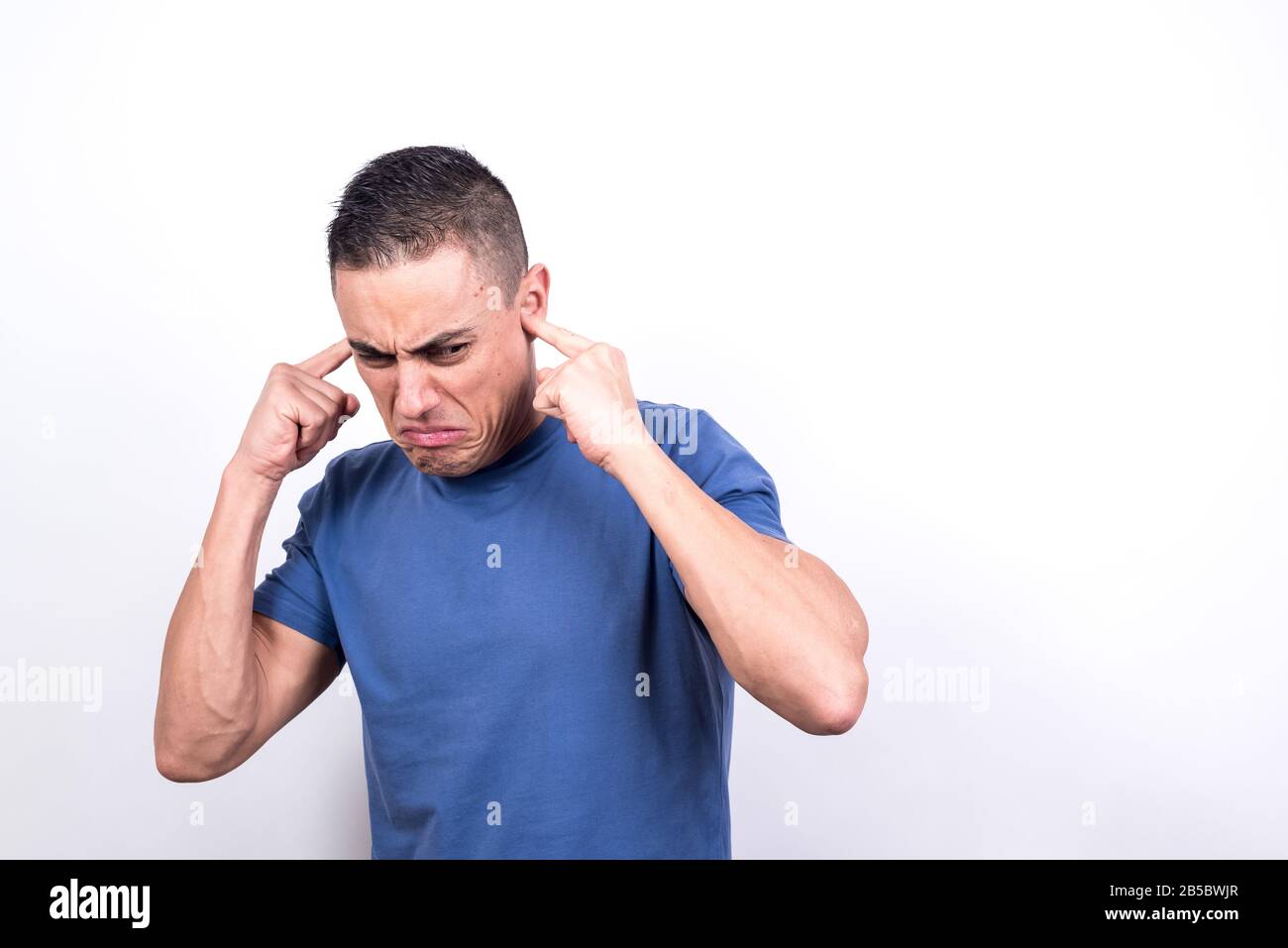 Man disgusted by noise. White background, Medium shot Stock Photo - Alamy