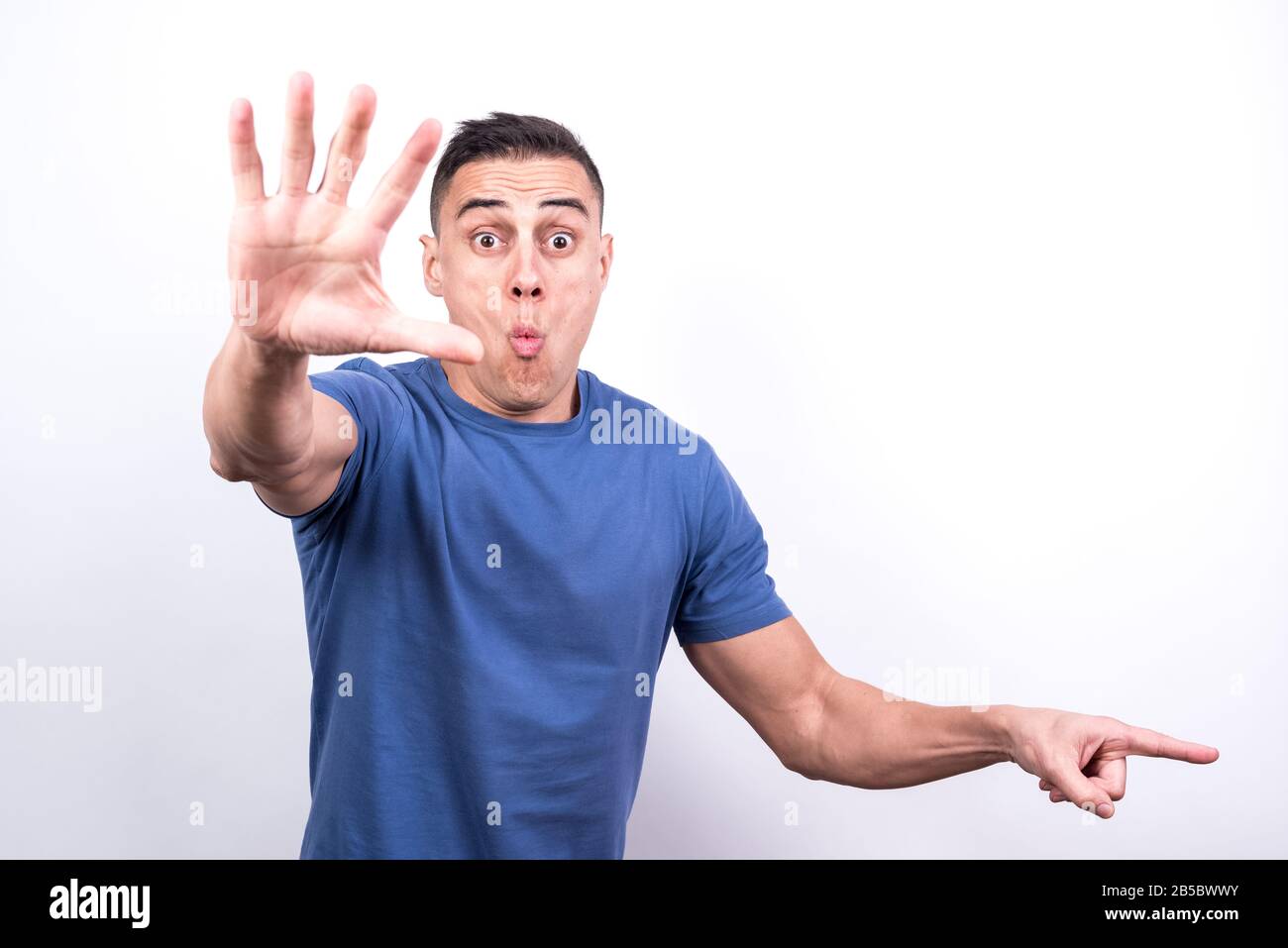 Surprised man pointing to copy space. White background, Medium shot ...
