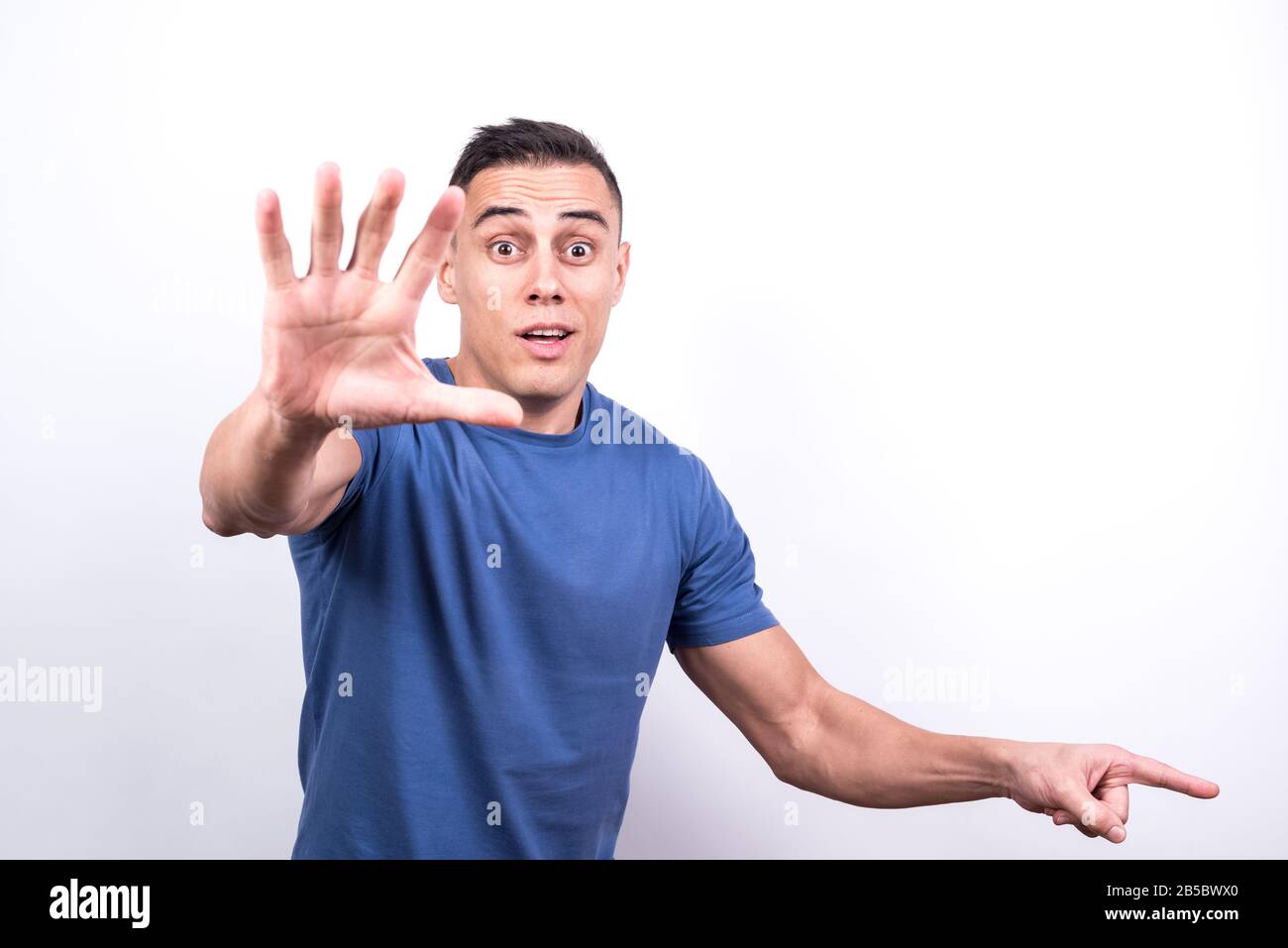 Surprised man pointing to copy space. White background, Medium shot ...
