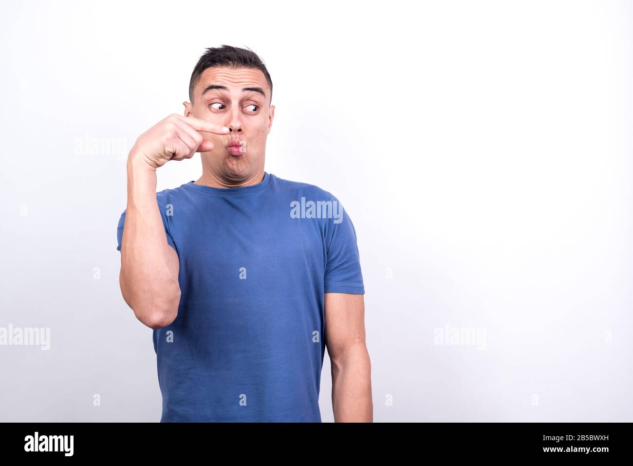 Surprised man pointing to copy space. White background, Medium shot ...