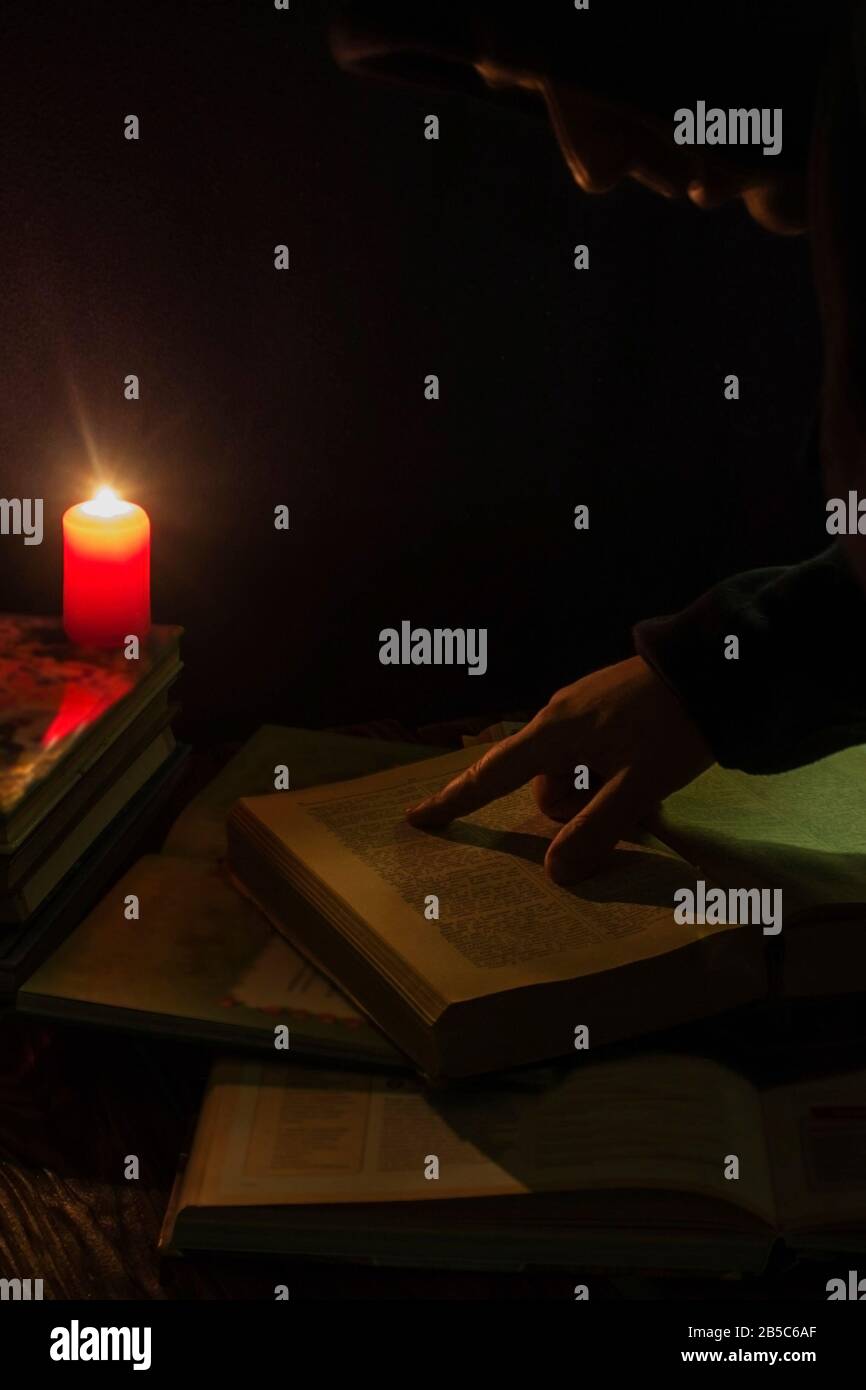 Burning candle reading book hi-res stock photography and images - Alamy