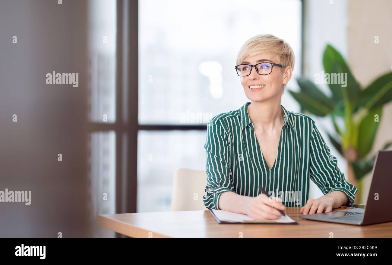Business Lady Taking Notes Looking Aside Sitting In Modern Office Stock ...