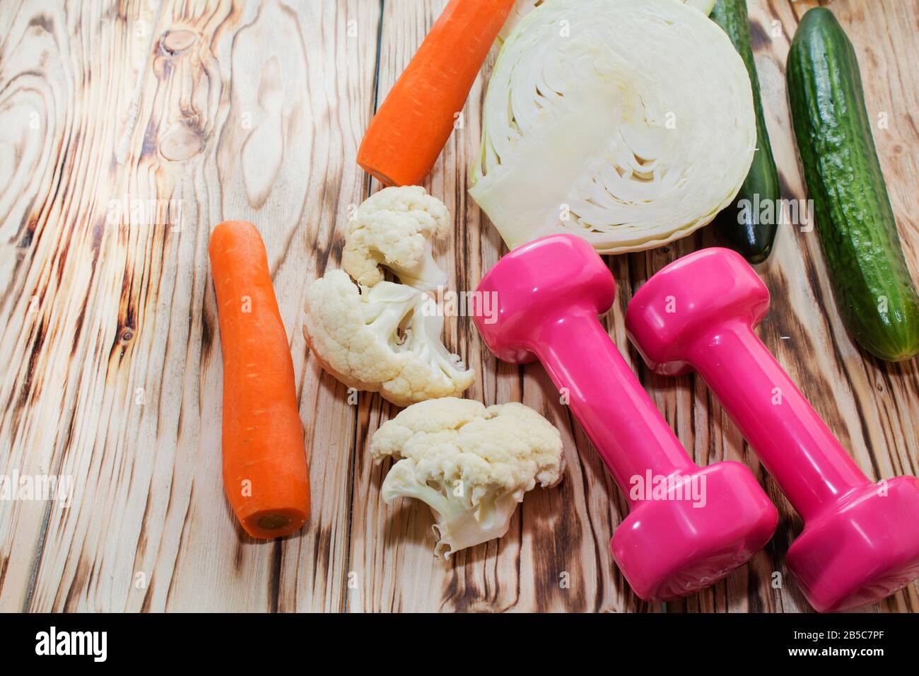 Fitness concept with dumbbells and healthy food. Vegetarianism in the ...