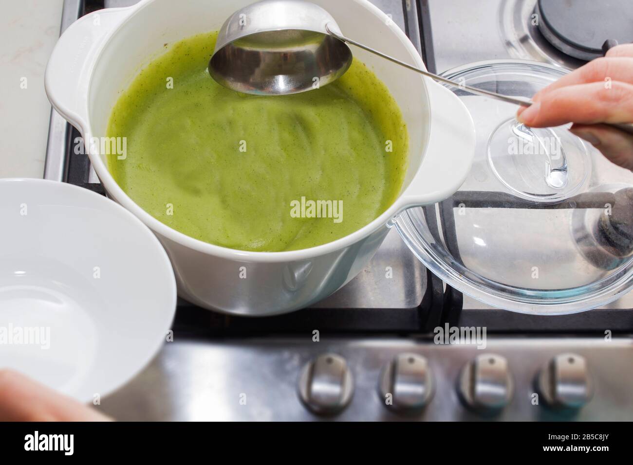 Preparation puree the soup closeup in white pot Stock Photo - Alamy