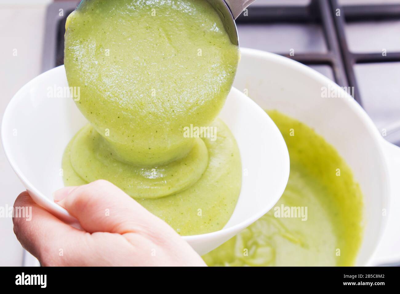 Preparation puree the soup closeup in white pot Stock Photo - Alamy