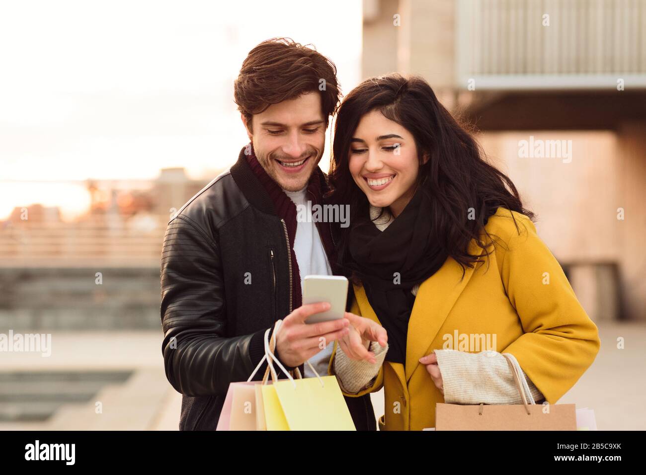 Loving couple using mobile phone hi-res stock photography and images ...