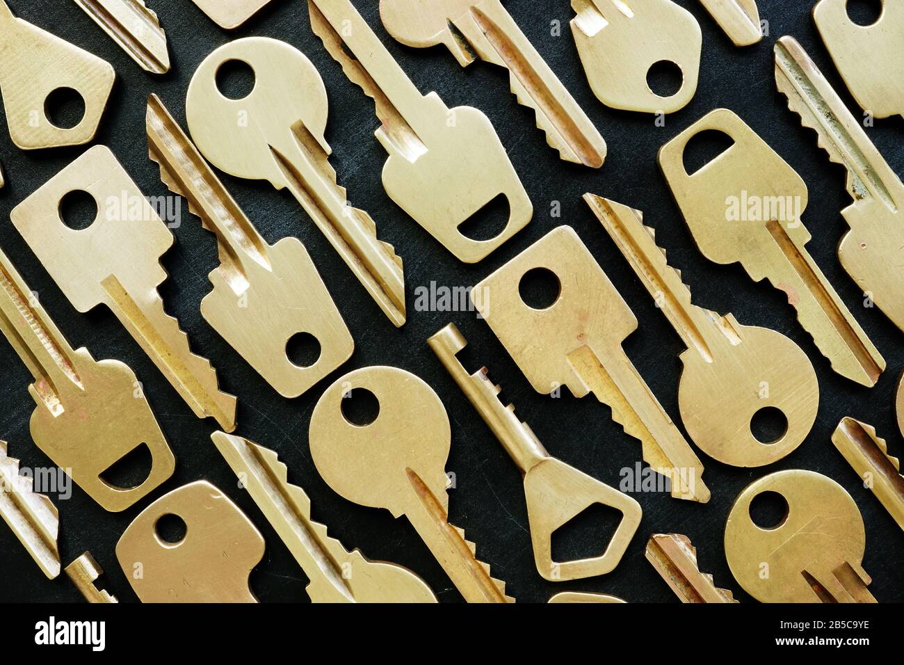 Lot of different yellow keys on dark background. Different ...