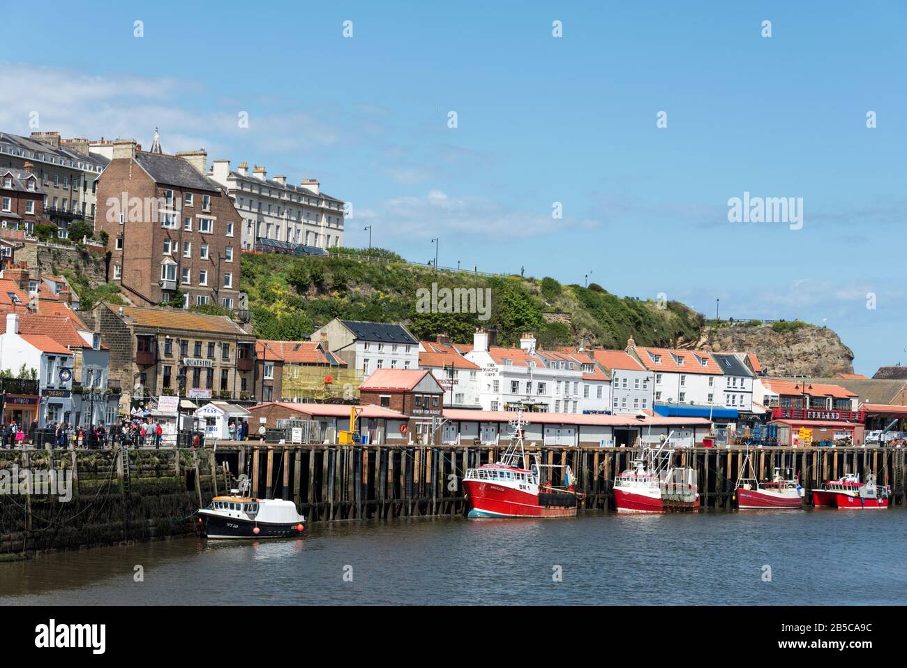 A small fleet of moored red fishing trawlers on the River Esk at Whitby ...