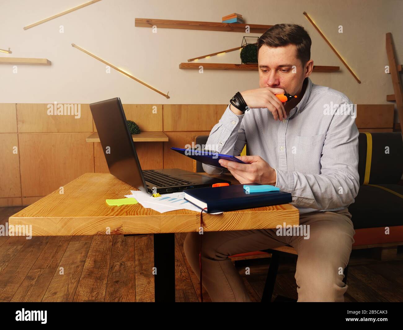 A man analyzes financial statements and works with a computer Stock ...