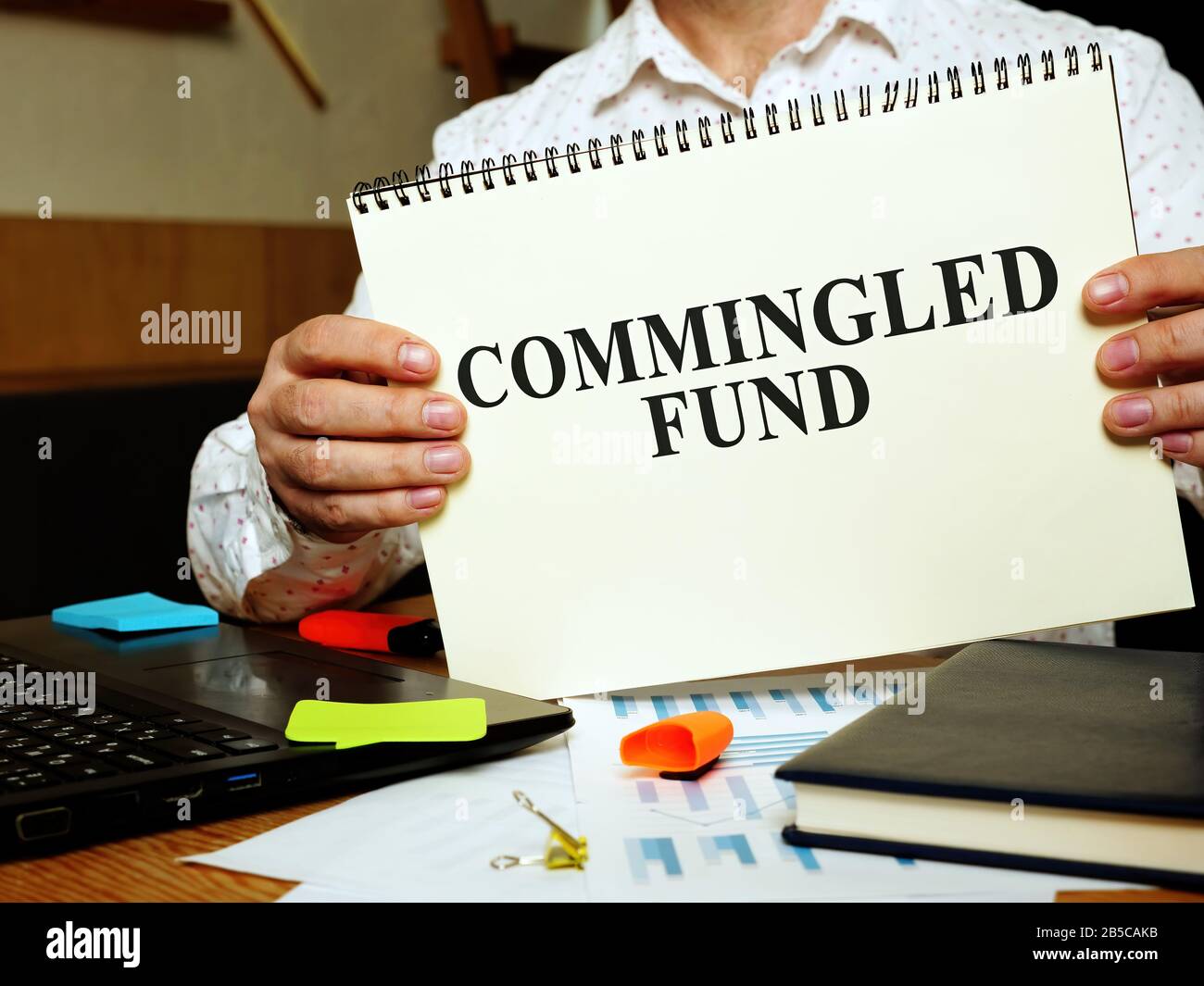 Commingled Fund papers in the man hands Stock Photo - Alamy