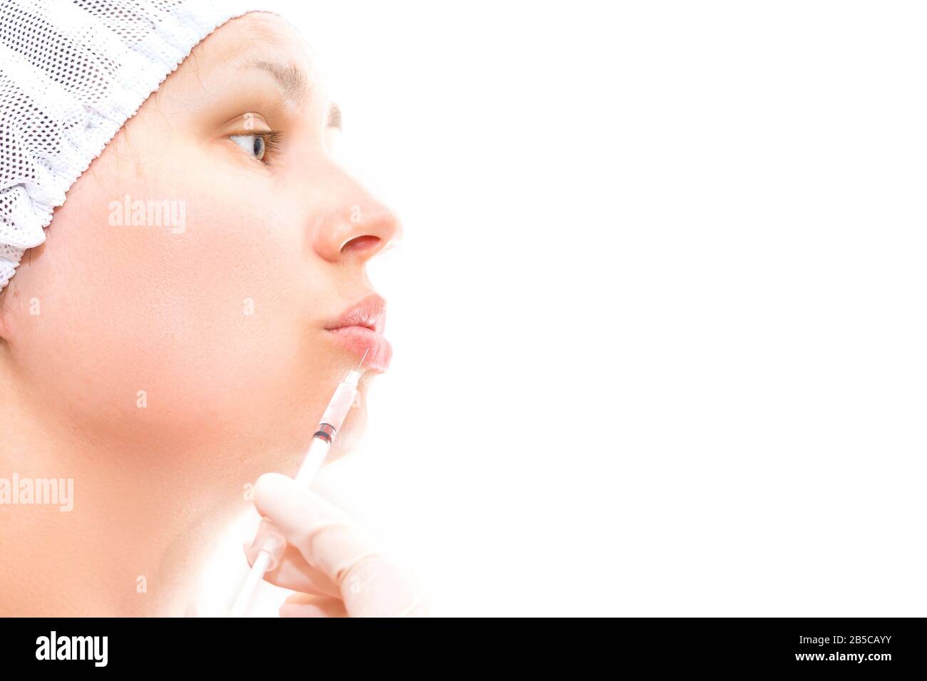 young woman gets injection in her lips. Woman in beauty salon. plastic ...
