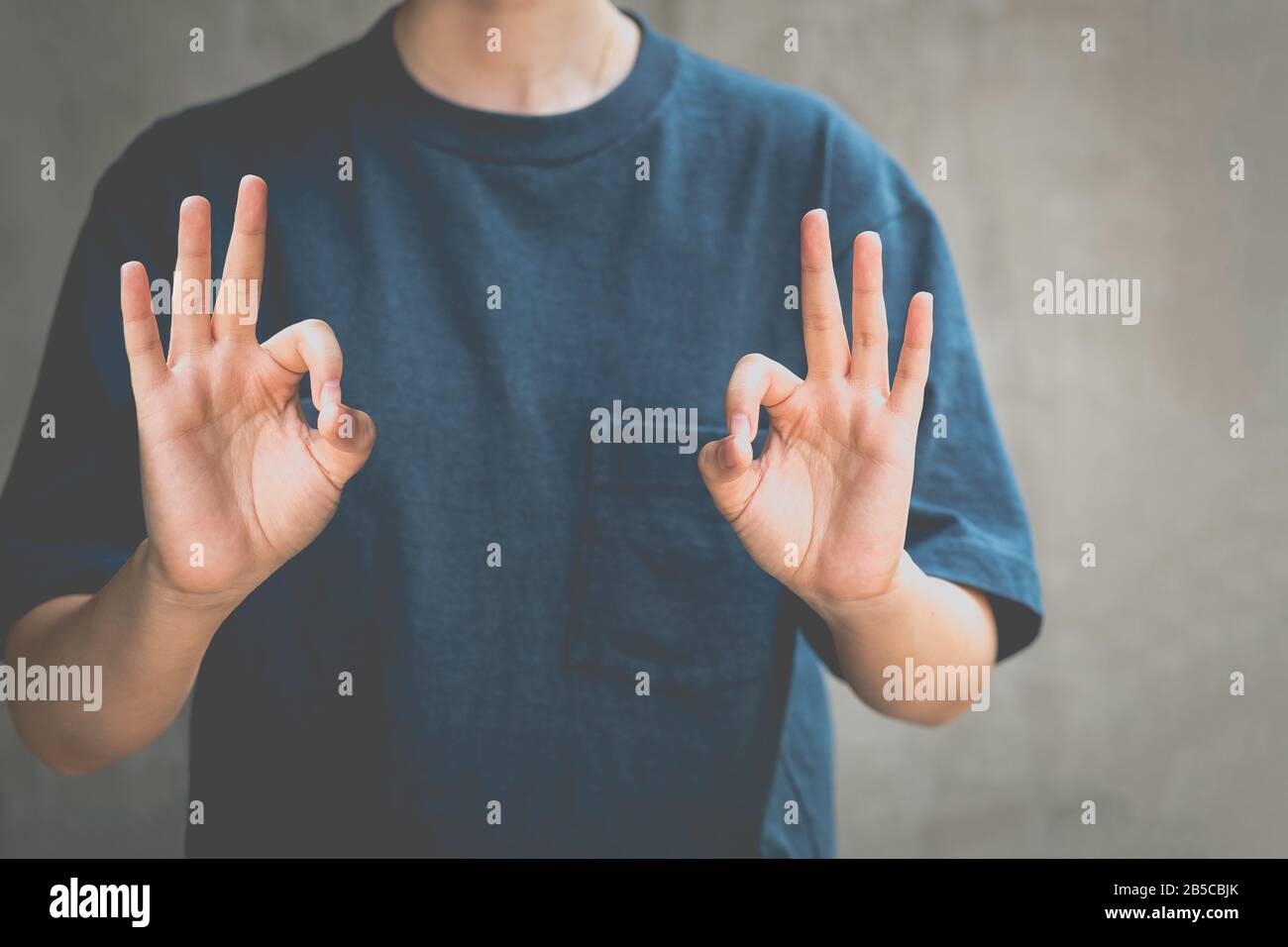 Woman standing and positive hand sign approving conceptual Stock Photo ...
