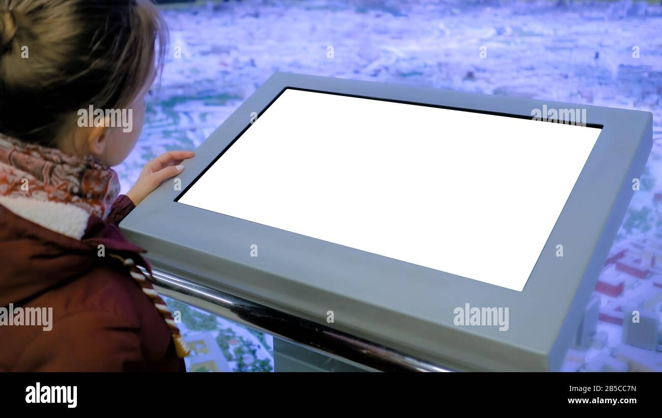 White screen concept - woman looking at blank interactive white display ...