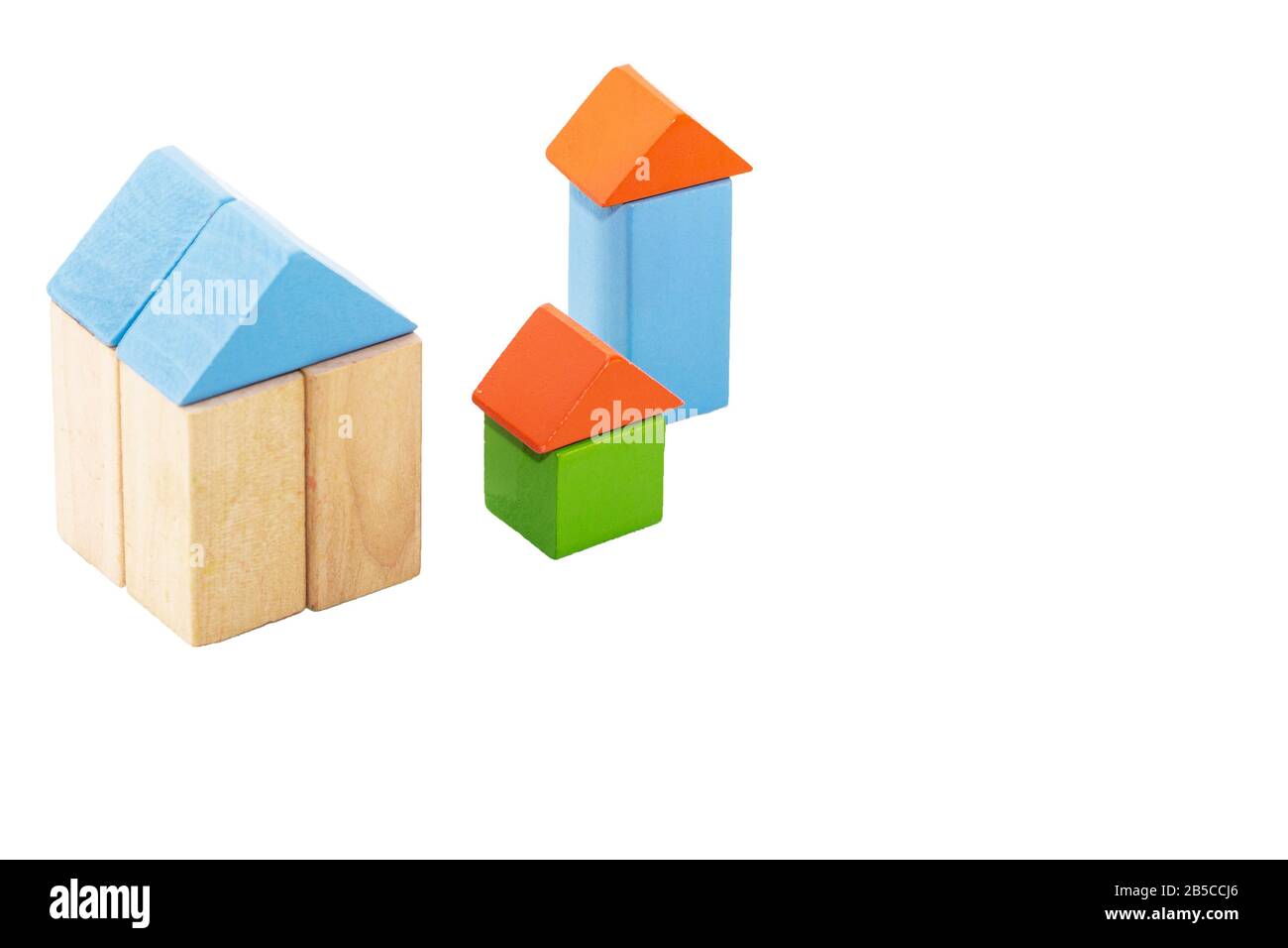 Houses made from children's wooden building blocks on a white ...