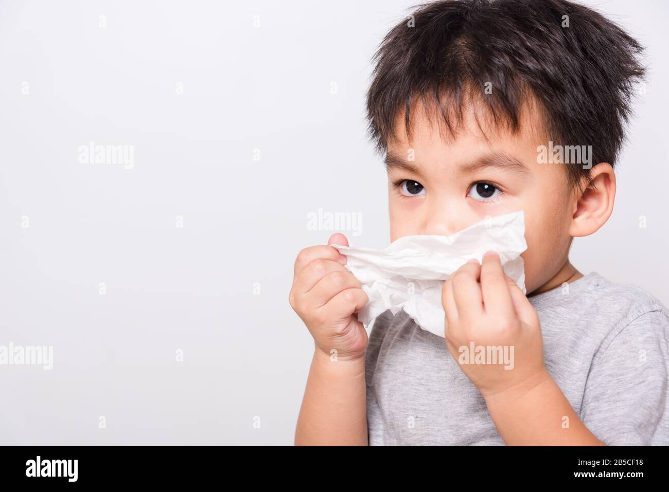Closeup Asian face, Little children boy cleaning nose with tissue on ...