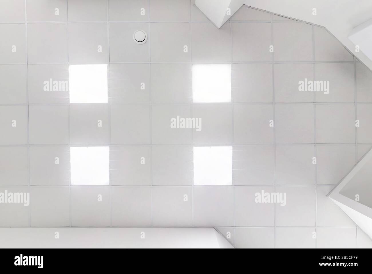 cassette suspended ceiling with square halogen spots lamps and drywall ...