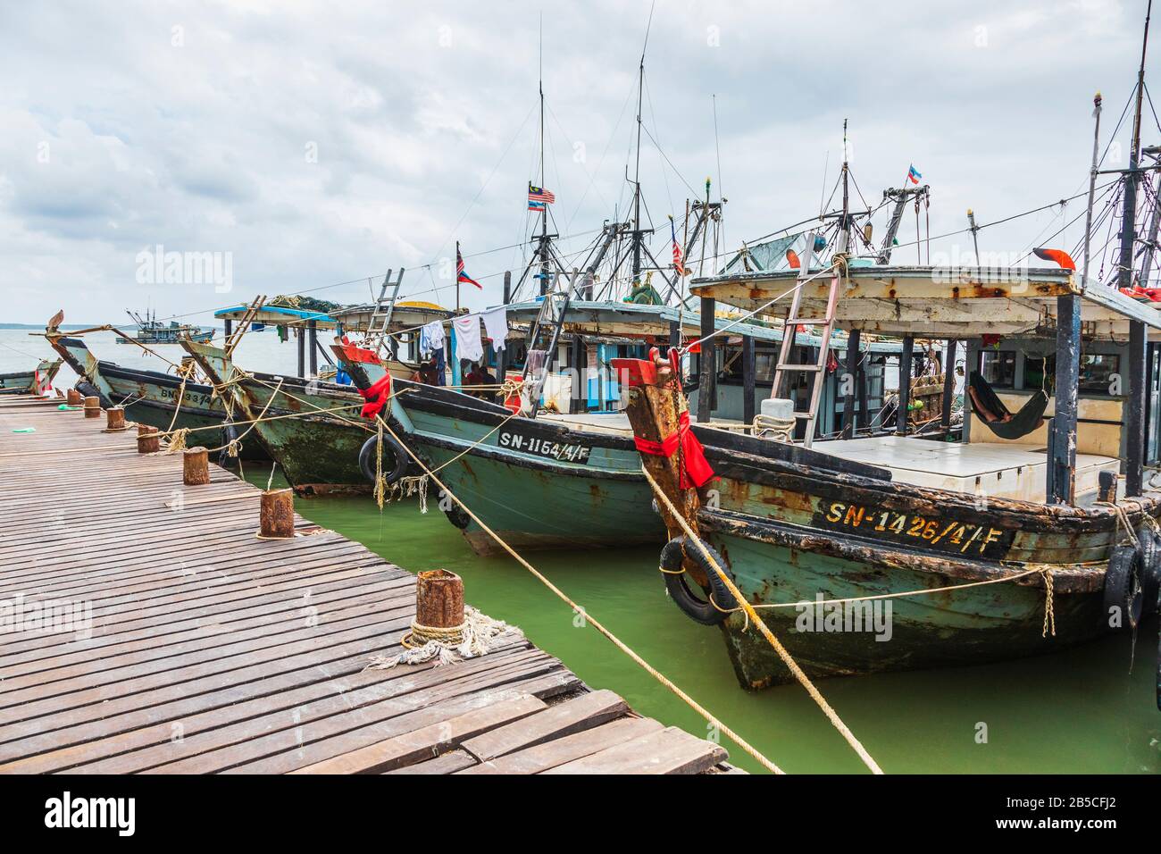Local fishing boats tied up at Sandakan harbour on Sulu Sea, Sabah ...