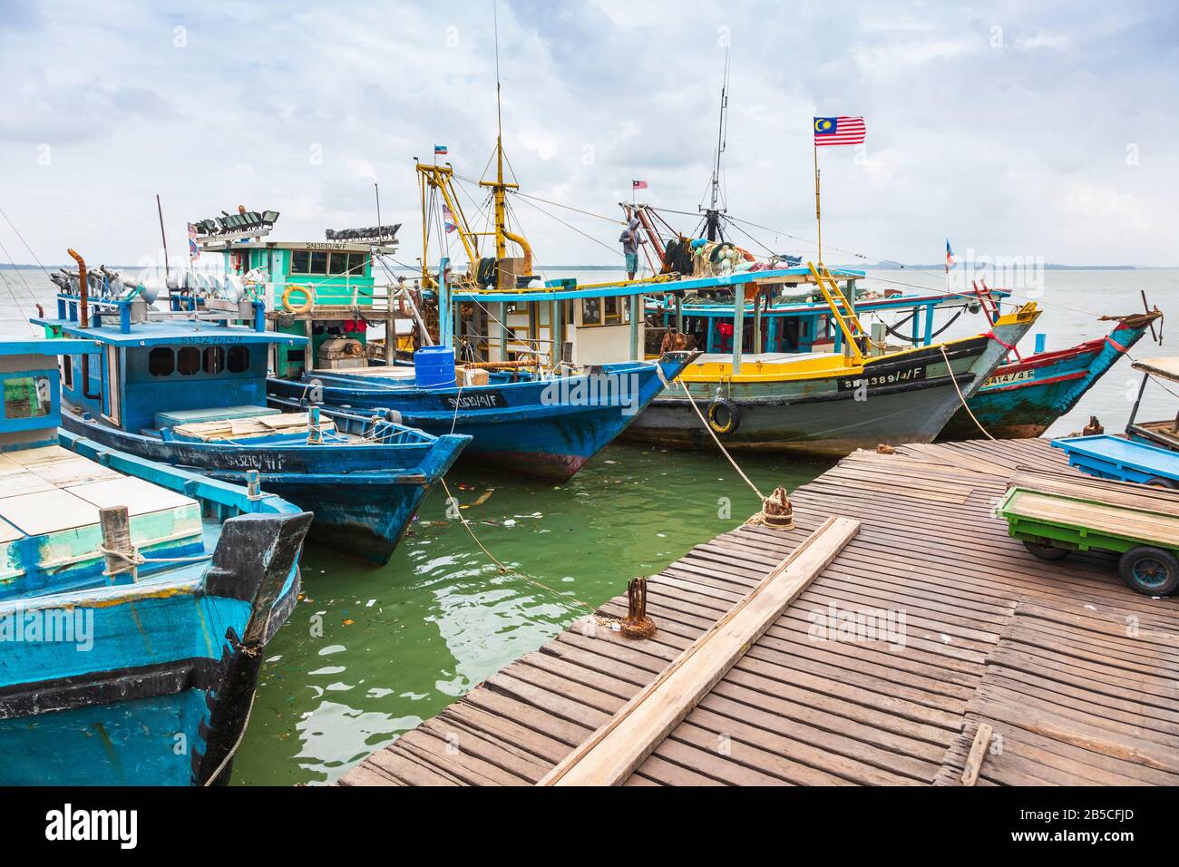 Local fishing boats tied up at Sandakan harbour on Sulu Sea, Sabah ...
