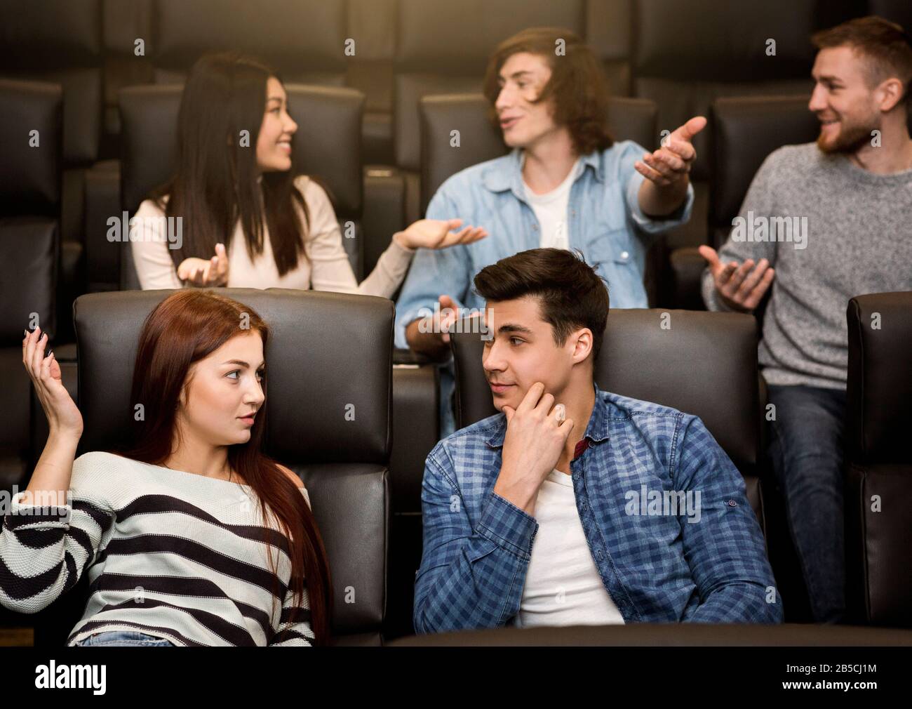 Male friends talking hall hi-res stock photography and images - Alamy