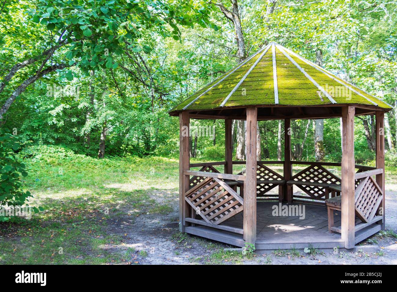 open wooden gazebo with a roof of moss in a beautiful forest Stock ...