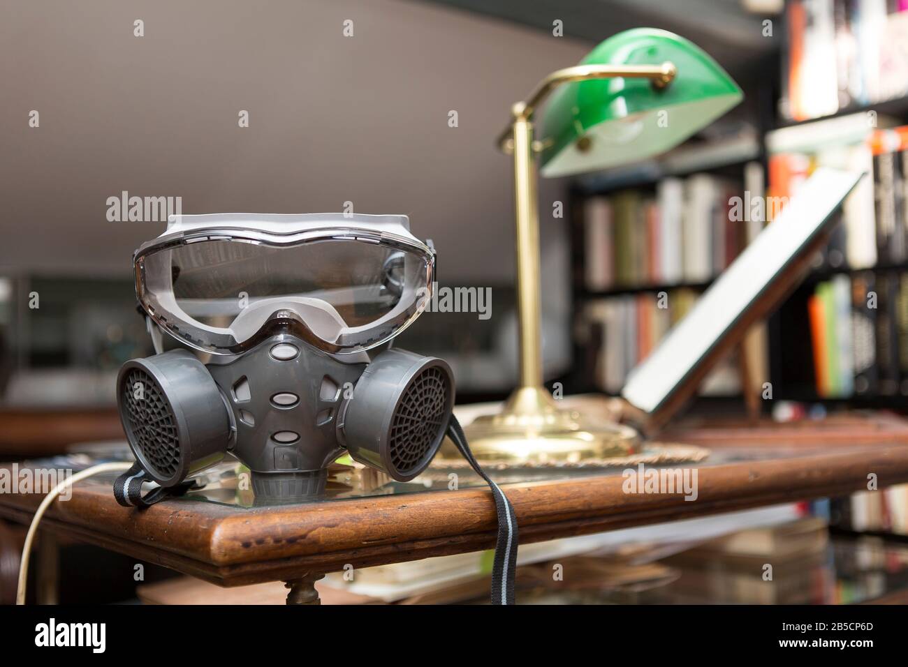 Coronavirus concept: close up on a gas mask placed inside a domestic ...