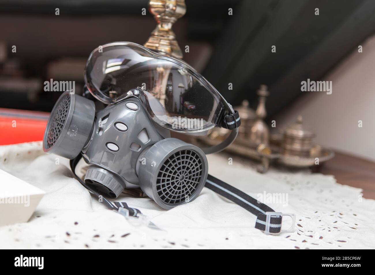 Coronavirus concept: close up on a gas mask placed inside a domestic ...