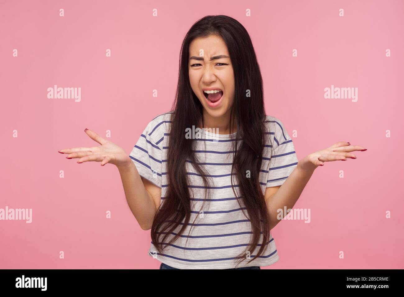 What do you want? Portrait of enraged irritated girl with brunette hair ...