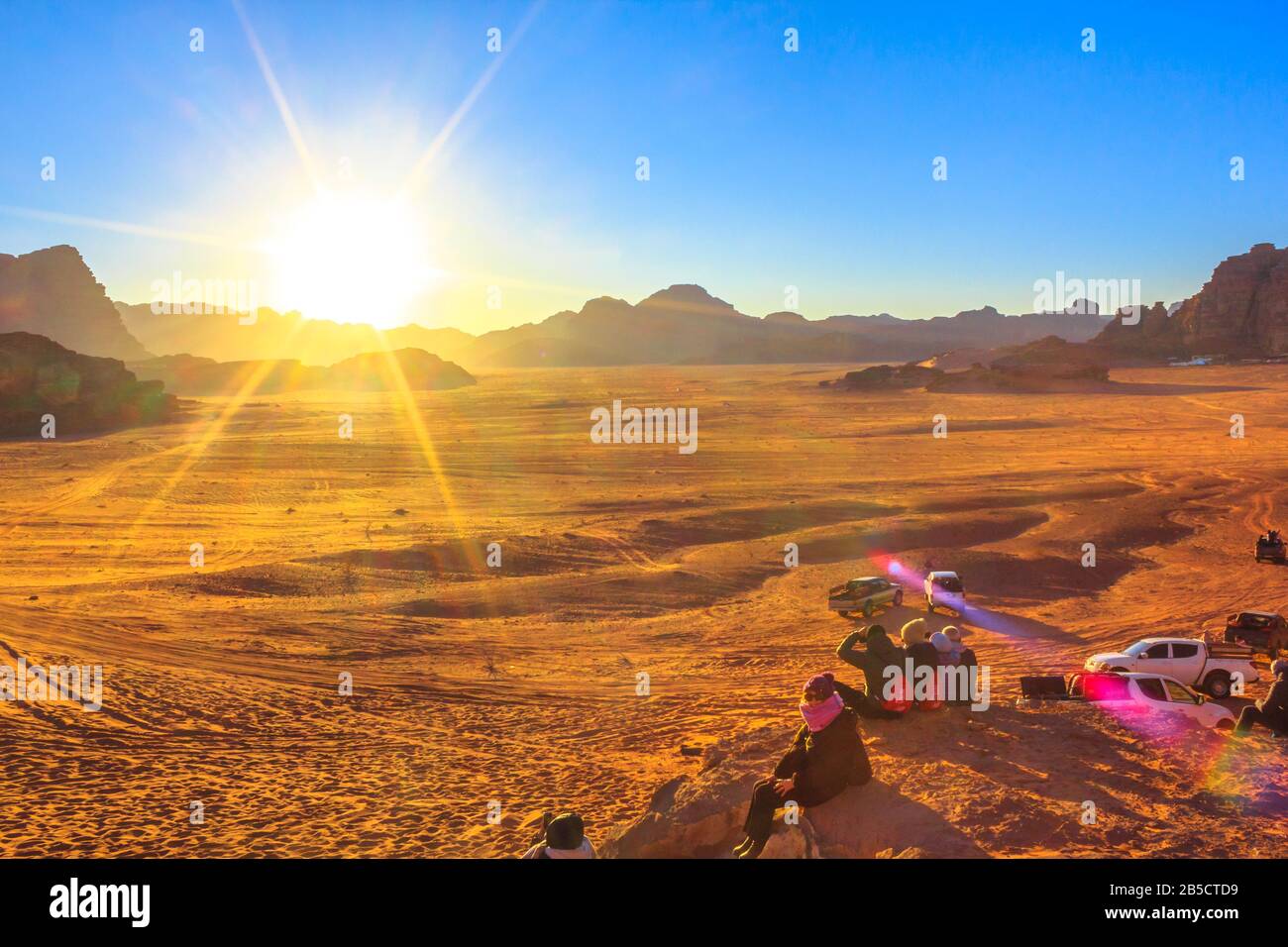 Aqaba, Jordan - Jan 5, 2020: people sitting on top of the red dunes of ...