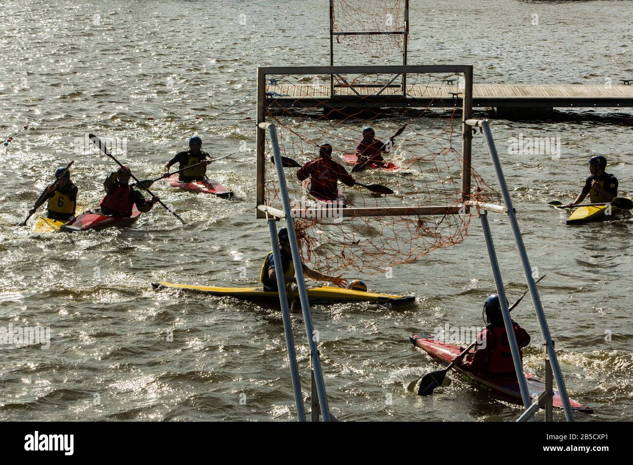 Teams of kayakers compete in a kayak polo match, Bristol, Avon, England ...