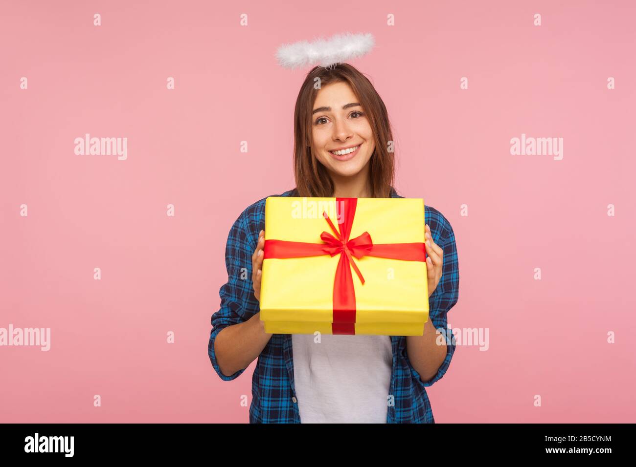 Present from angel. Portrait of generous happy beautiful girl with halo ...