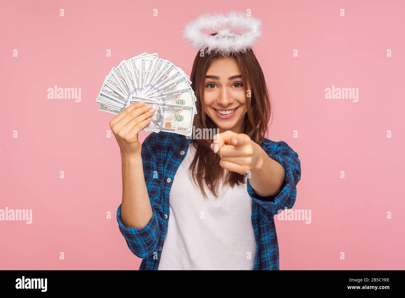 You may become rich! Portrait of happy lucky angelic girl with halo ...
