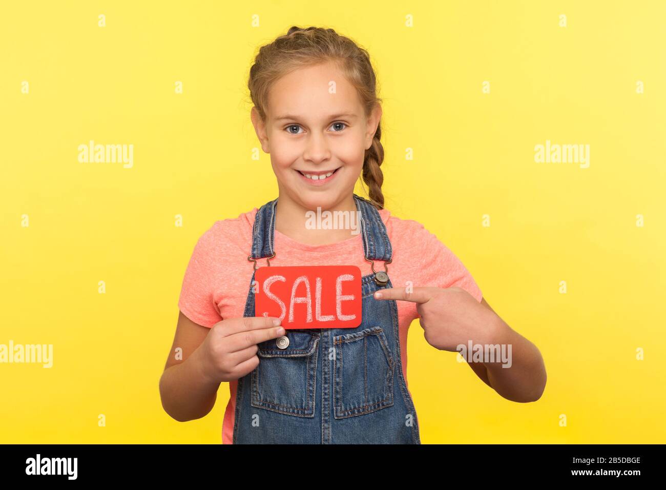 Attention to holiday discounts! Portrait of cute happy little girl with ...