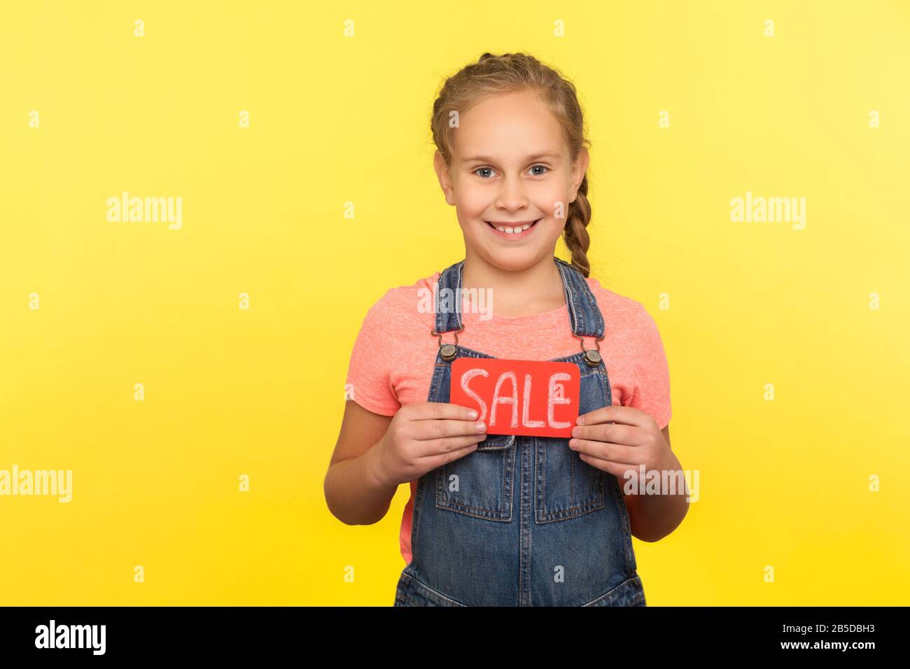 Holiday discounts! Portrait of cute cheerful little girl with braid in ...