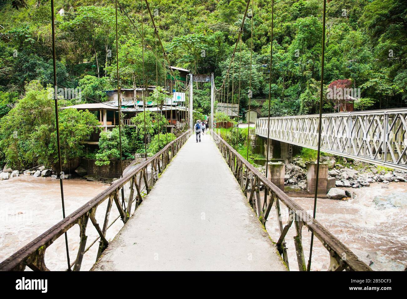 Machu Picchu Pueblo, Peru - Jan 8, 2019: Tourists cross bridge over ...