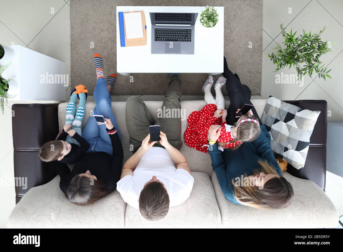 Family using electronic gadgets hi-res stock photography and images - Alamy
