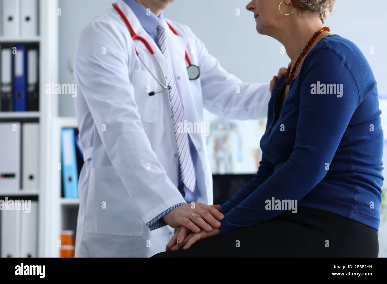 Physician supporting ill patient Stock Photo - Alamy