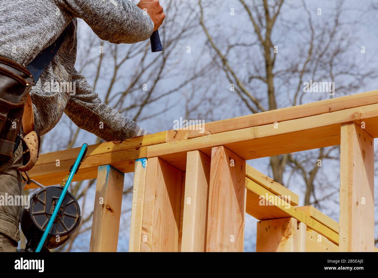 Contractor framing up wall section for a framing building custom house ...